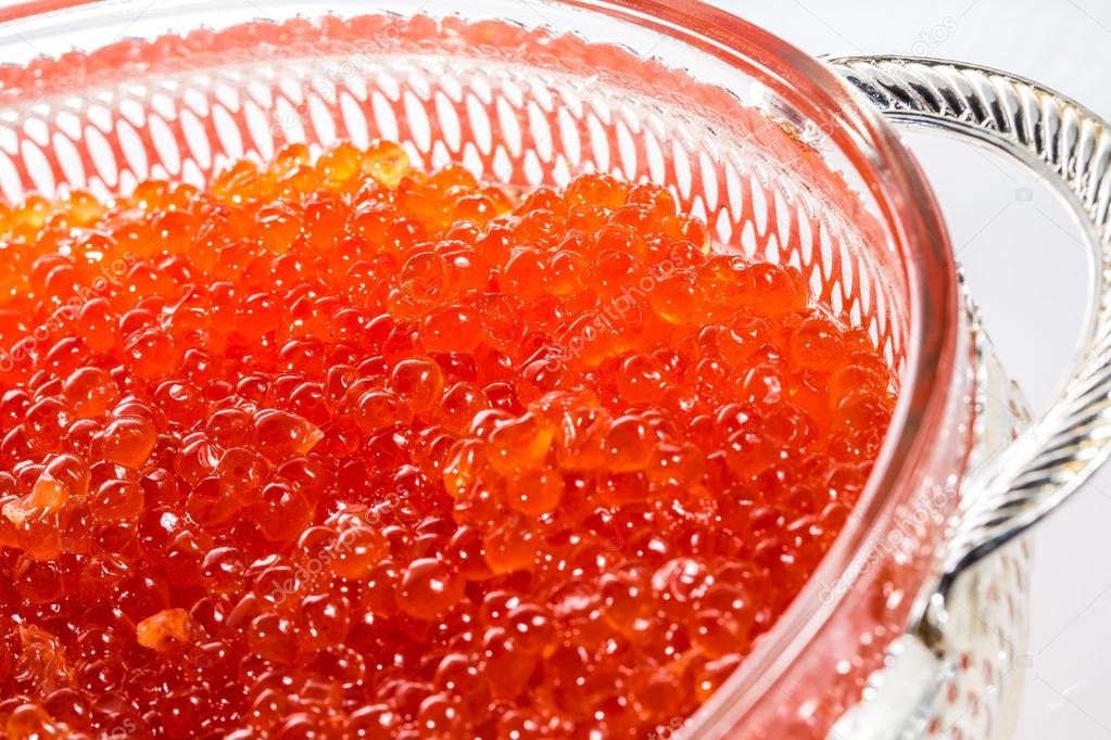 Red caviar in silver bowl isolated on white — Stock Photo © sarymsakov ...