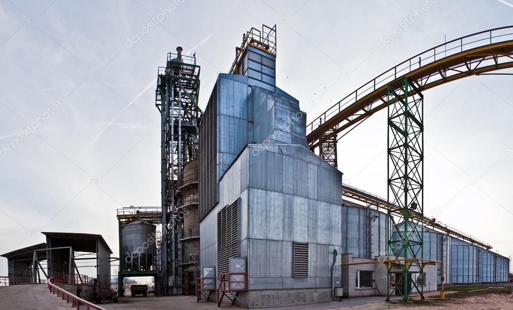 Towers of grain drying enterprise at sunny day Stock Photo by ...