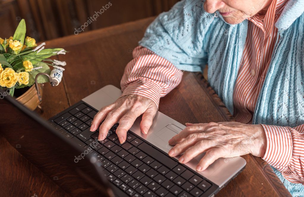 Old woman using a laptop — Stock Photo © thodonal #104886488