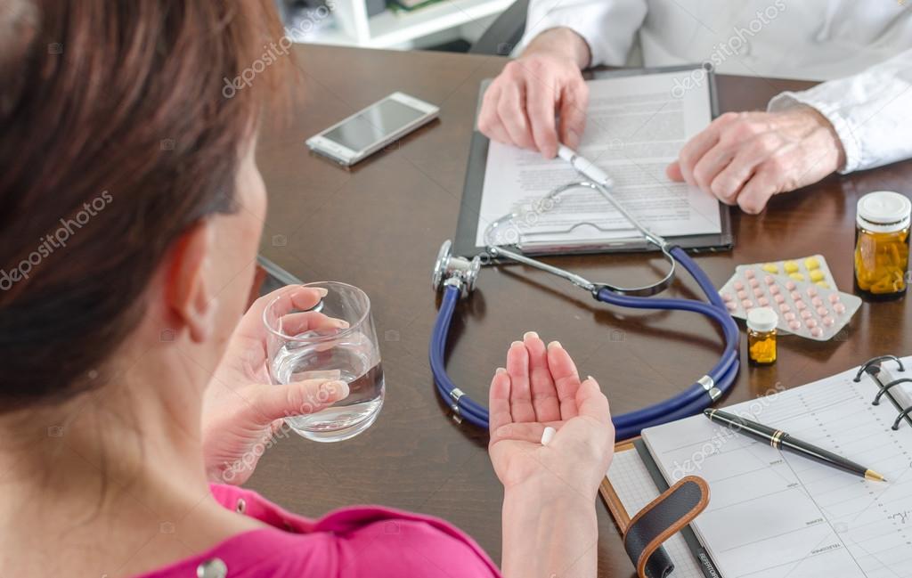 Patient taking her medicine Stock Photo by ©thodonal 78596558