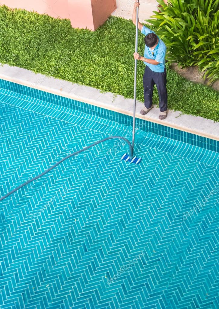 Worker cleaning the pool. Stock Photo by ©moccabunny 58475493