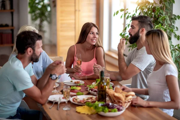 Group of friends have lunch together at home. - Stock Image - Everypixel