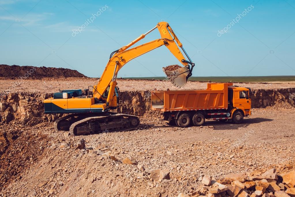Excavator Loads Gravel into a Truck on a Crushed Stone Quarry Stock ...