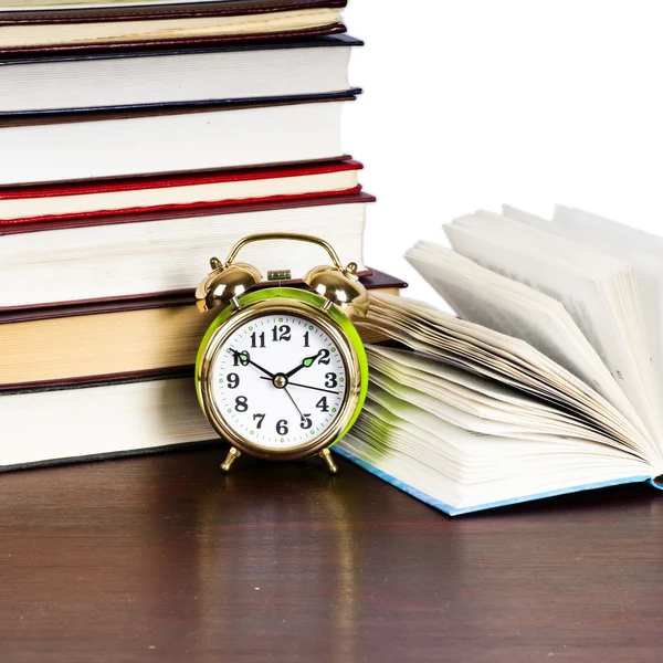 Time to learn. Books and alarm clock on the table - Stock Image ...