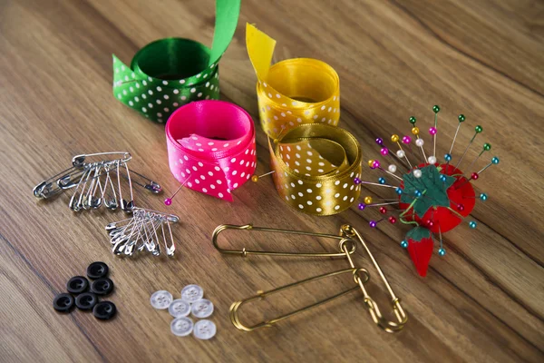 Sewing kit. Colored thread, pins, buttons, ribbons, safety pin. - Stock ...