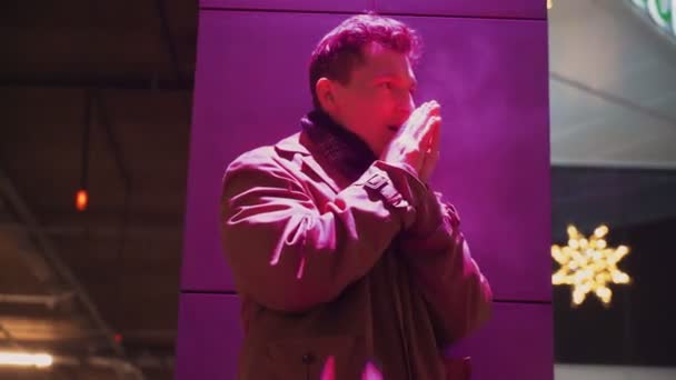 Man freezing from cold standing near roadway and shopping center at ...