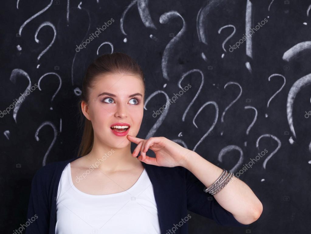 Young girl with question mark on a gray background — Stock Photo ...