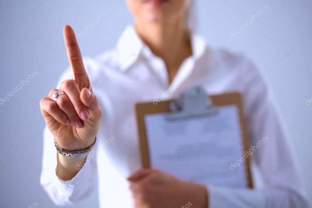 Woman touching an imaginary screen with her finger , holding a folder ...