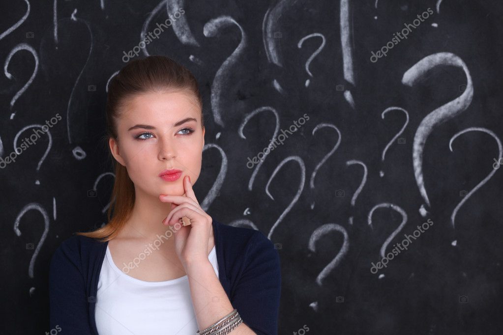 Young girl with question mark on a gray background Stock Photo by ...