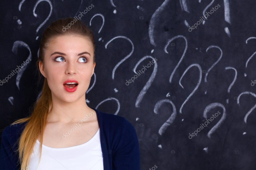 Young girl with question mark on a gray background Stock Photo by ...