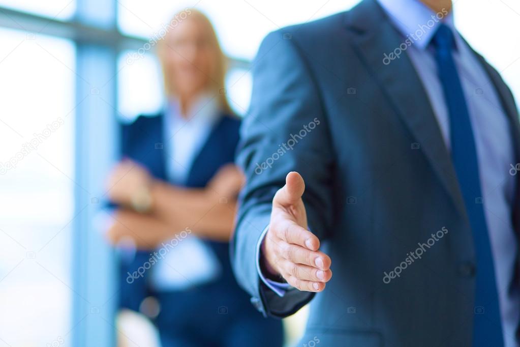 Young businessman ready to handshake standing in office — Stock Photo ...