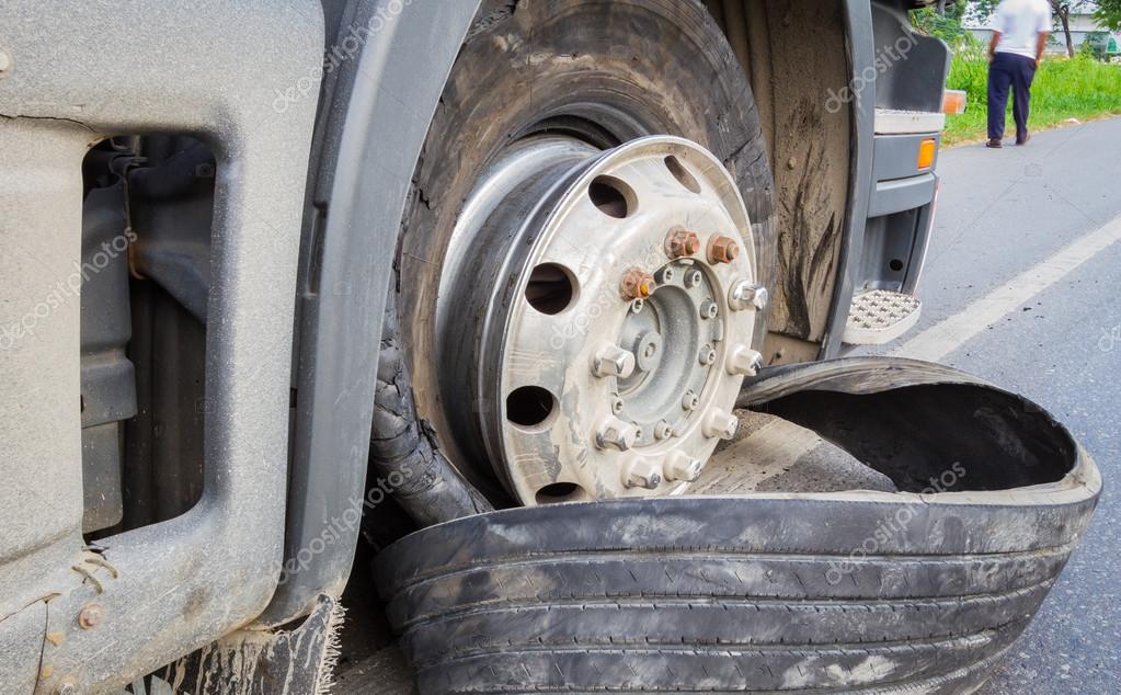 Damaged 18 wheeler semi truck burst tires by highway street, wit ...