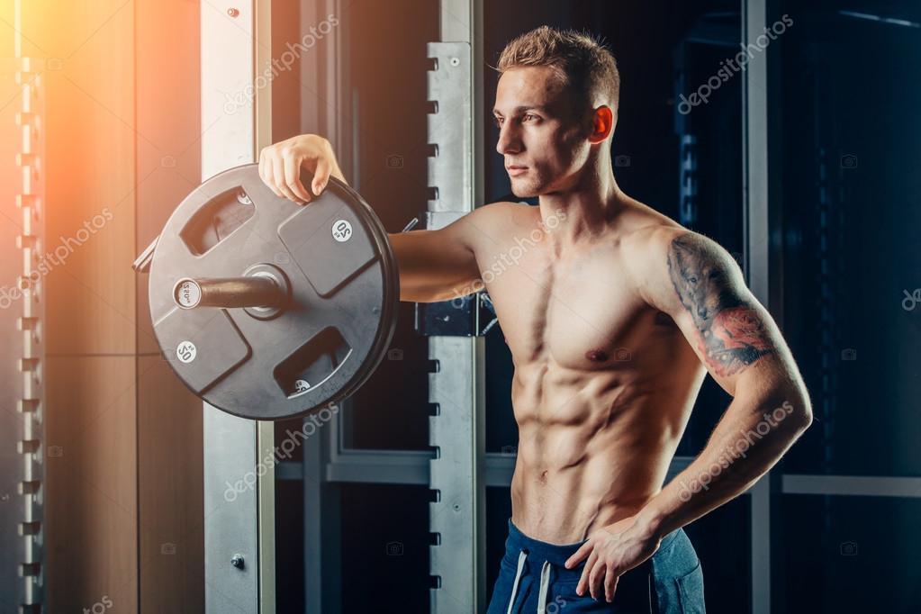 Closeup Portrait Of A Muscular Man Workout With Barbell At Gym Brutal