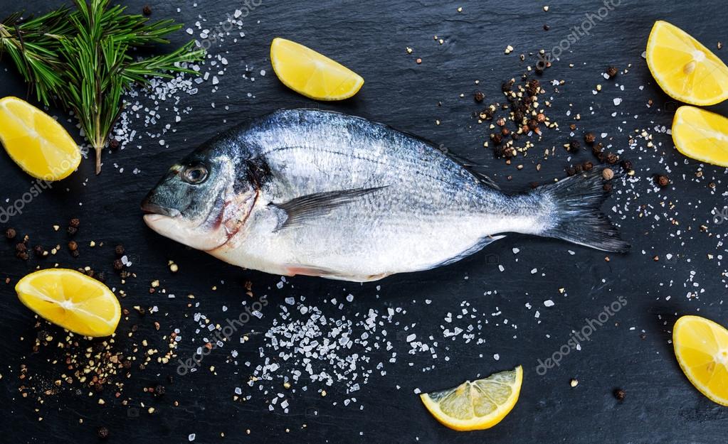 Fresh Raw Sea Bream Fish on blue stone background. Stock Photo by ...