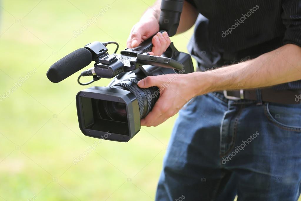 Video camera man with camera Stock Photo by ©marcoscisetti 53215609
