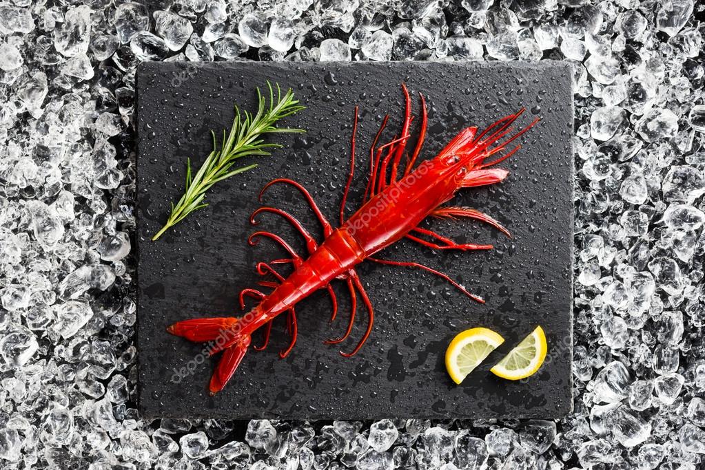 Fresh big red shrimp on ice on a black stone table top view — Stock ...
