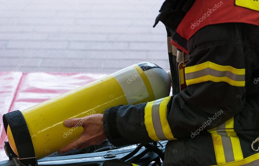 Oxygen cylinder in use with a firefighter Stock Photo by ©MBStudio 92416984