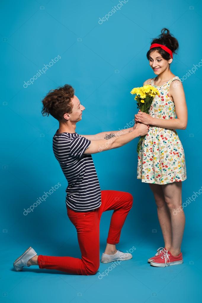 Surprised young woman getting flower from guy — Stock Photo © MrCat.com ...