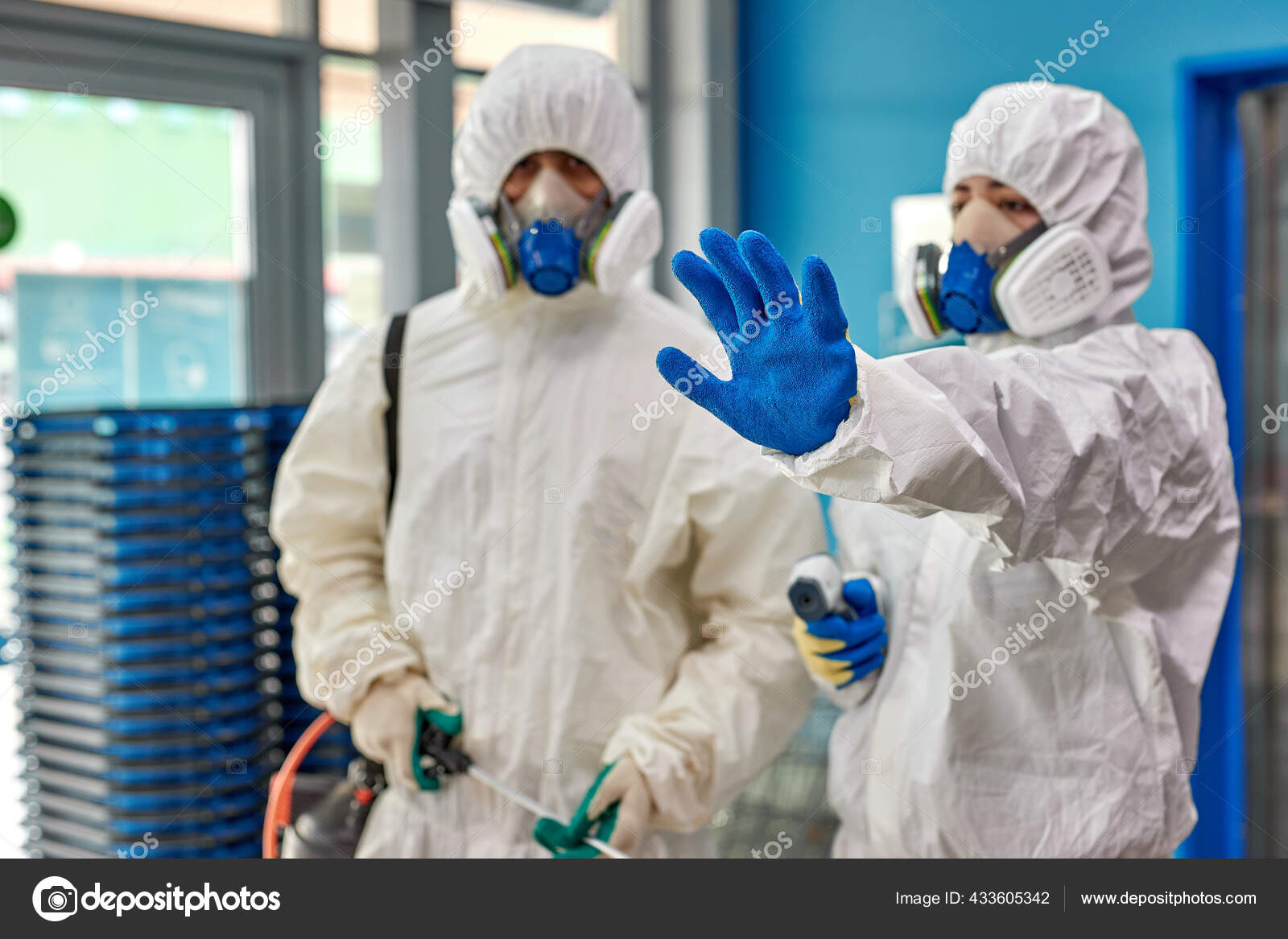 Stop, danger zone. man in protective hazmat suit stops, does not let to ...