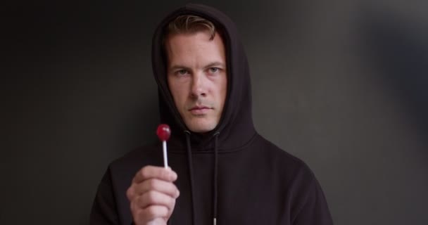 Stranger maniac in black wear offers candy to the child. Kids in danger ...