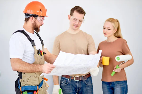 Confident Affable Builder Man In Overall Explain House Design To Family ...