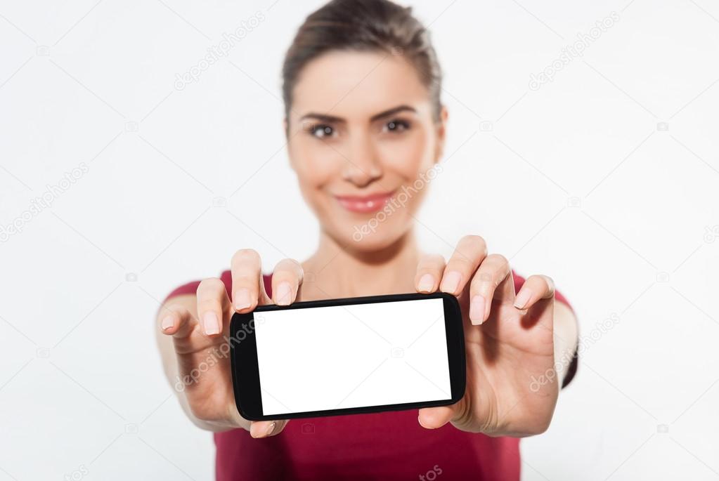 Young woman show display of mobile cell phone with white screen and ...