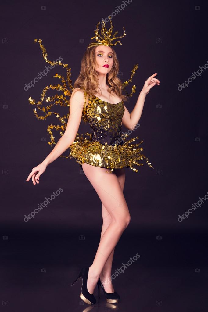 Sexy Disco Party Woman Dressed In A Unique Golden Costume With Metal Wings Perfect For Stylish