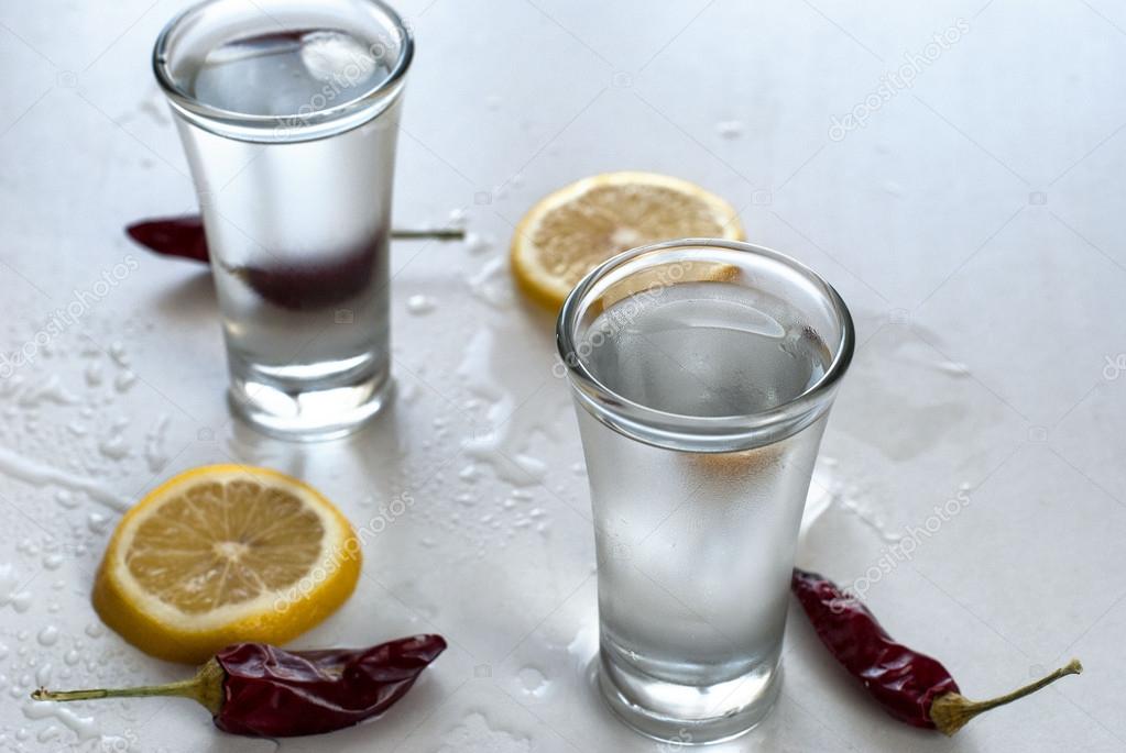 Cold vodka in a glass on a white wooden table — Stock Photo © vi-mart ...