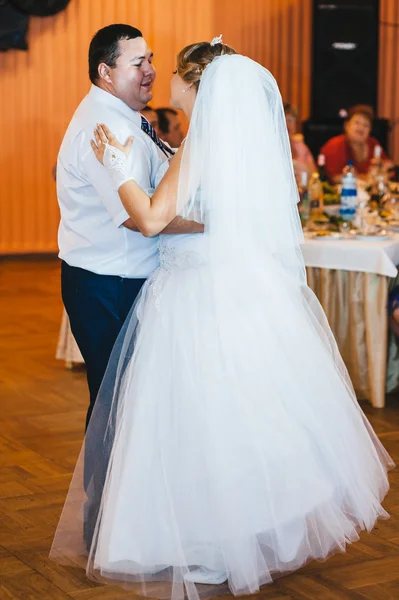 beautiful caucasian couple just married and dancing their first dance ...