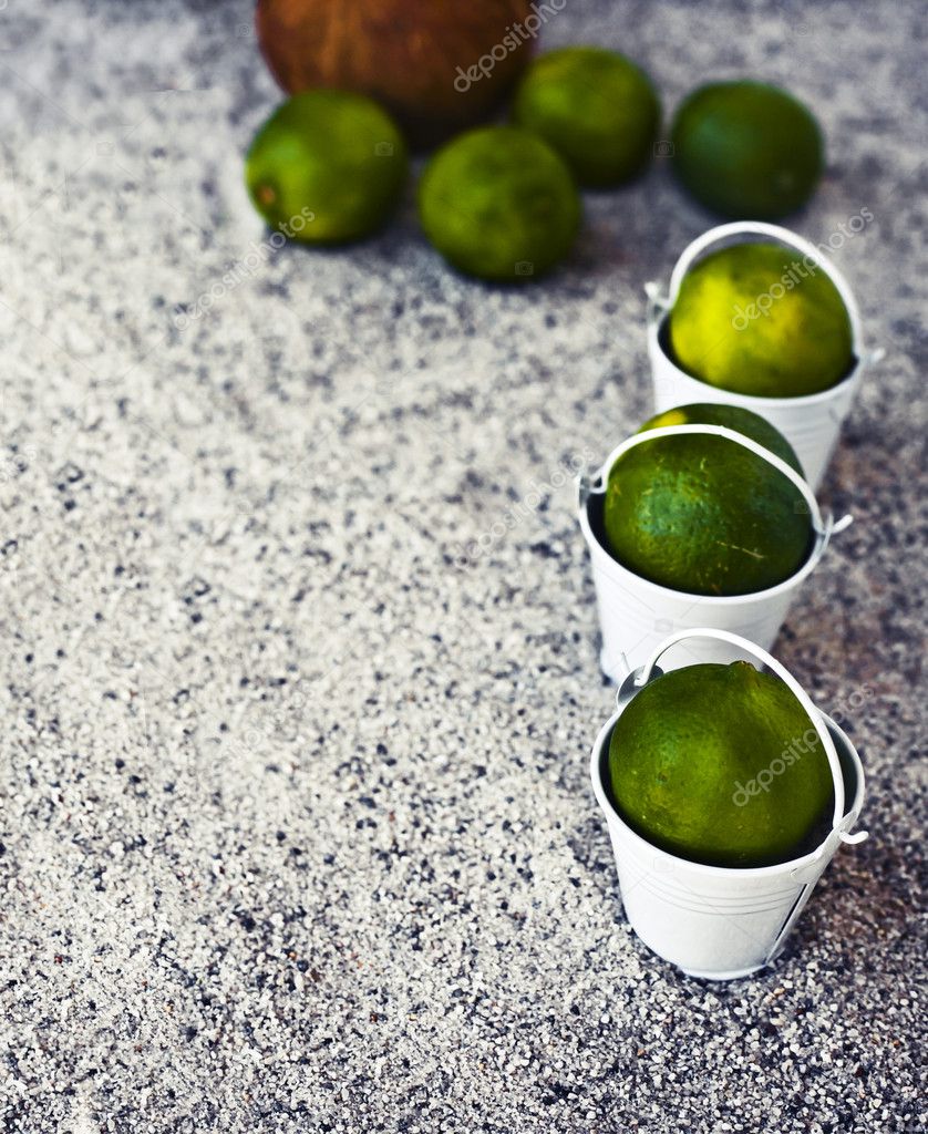 Little white buckets with limes — Stock Photo © artnature #60785809