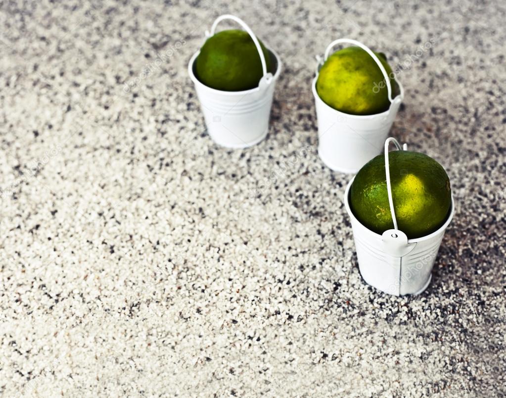 Little white buckets with limes Stock Photo by ©artnature 60785823