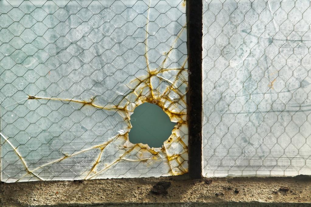 Hole in window, broken glass Stock Photo by ©artnature 66007333