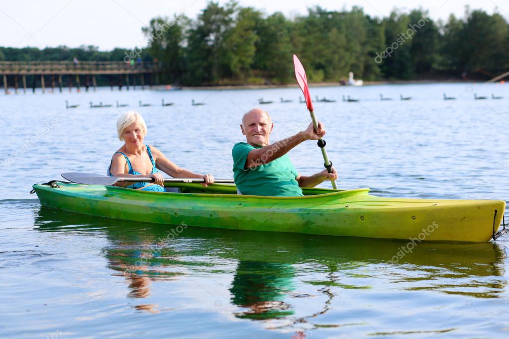 Seniors kayaking on the river — Stock Photo © CroMary #113838518