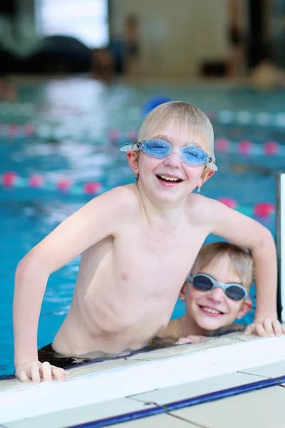 Two happy boys having fun in swimming pool Stock Photo by ©CroMary 63252919