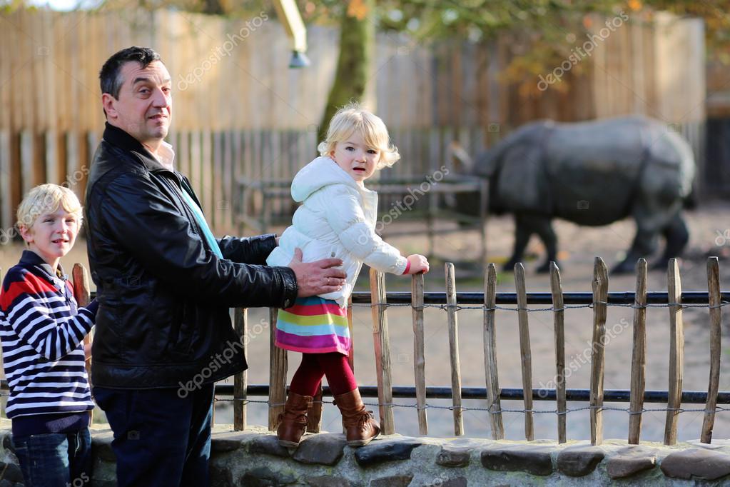 Father with kids having fun in the zoo — Stock Photo © CroMary #58951163