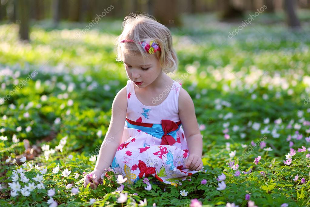 Adorable little girl enjoying spring blooming forest — Stock Photo ...