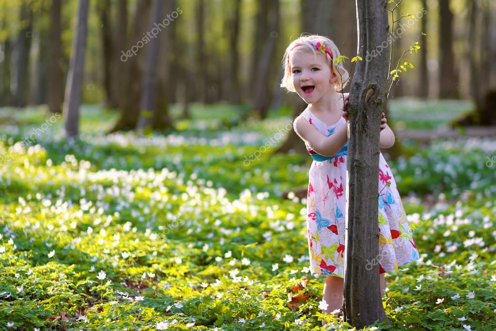 Adorable little girl enjoying spring blooming forest — Stock Photo ...