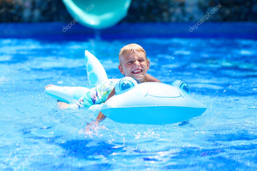 Happy boy having fun in swimming pool — Stock Photo © CroMary #73982709