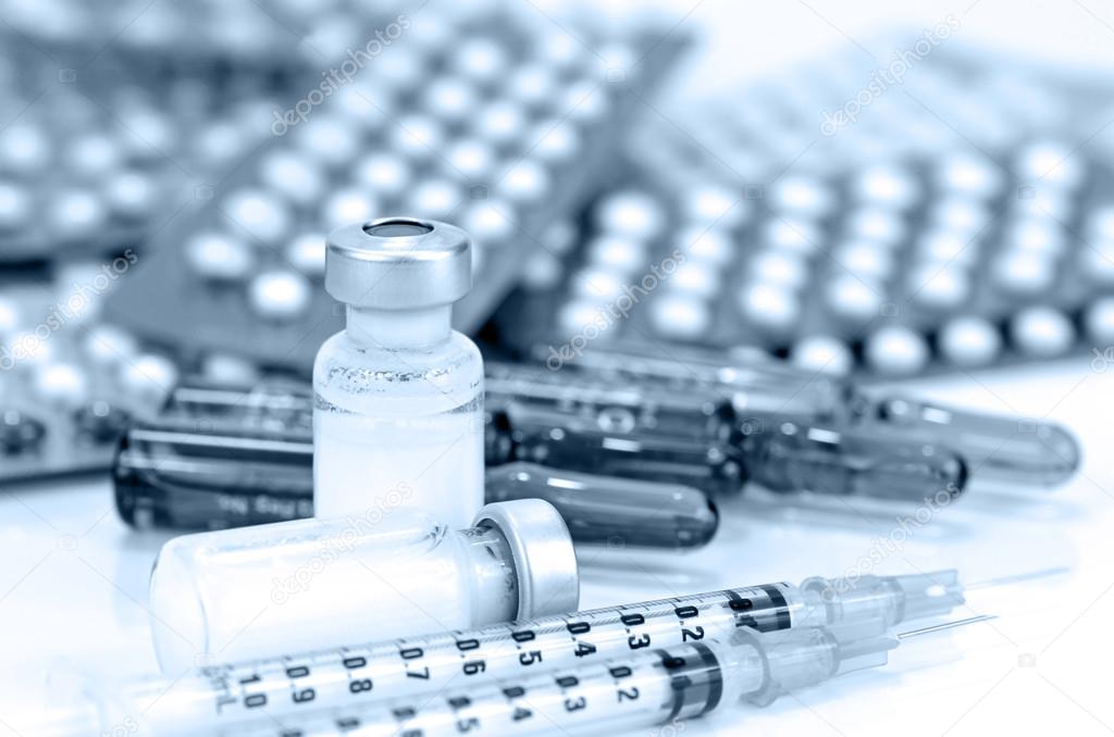 Injection medication with pills strips background. — Stock Photo ...