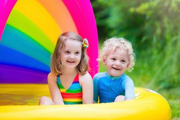 Kids playing in inflatable pool Stock Photo by ©FamVeldman 116285098