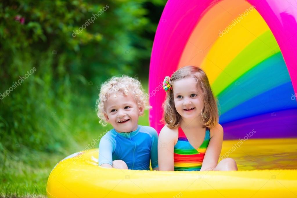 Kids playing in inflatable pool Stock Photo by ©FamVeldman 116285098