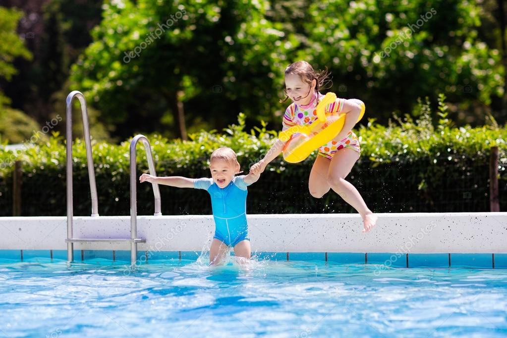 Kids jumping into swimming pool Stock Photo by ©FamVeldman 117417542