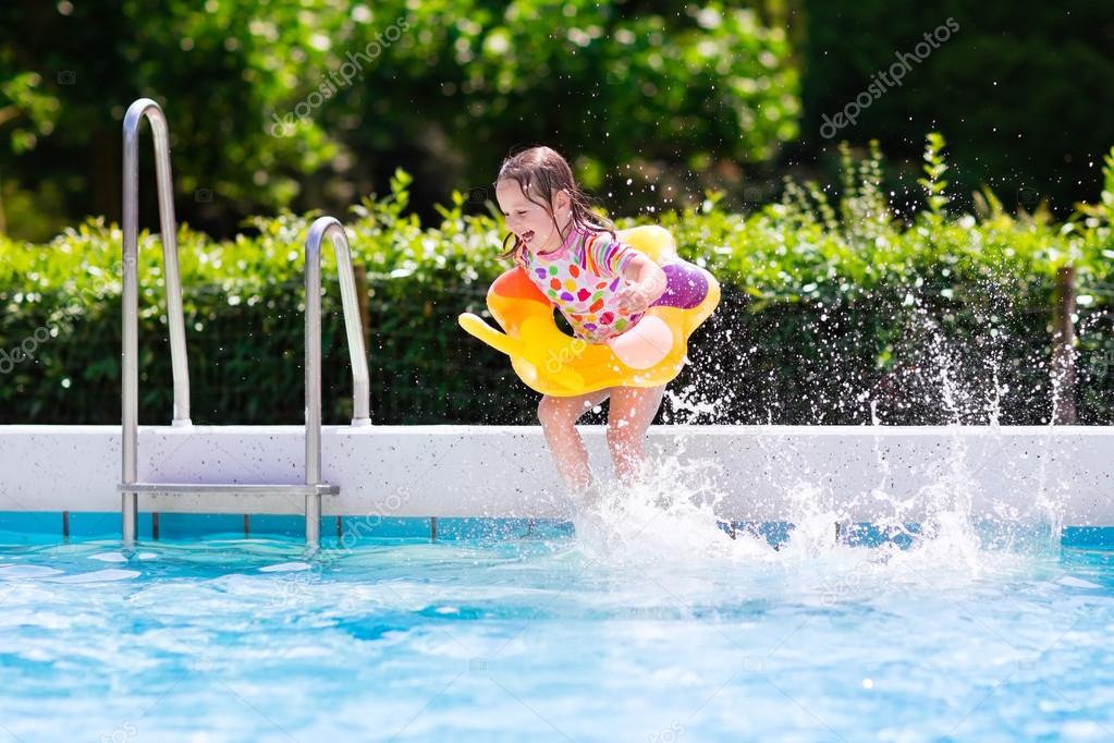 Kids jumping into swimming pool — Stock Photo © FamVeldman #117782252