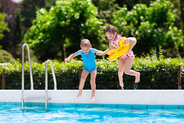 Kids jumping into swimming pool Stock Photo by ©FamVeldman 117417542