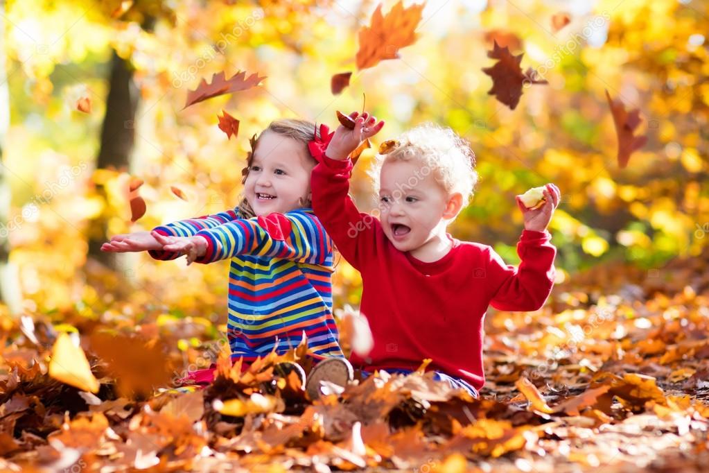 Kids playing in autumn park — Stock Photo © FamVeldman #119873730