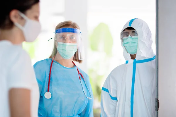 Covid-19 outbreak. Doctor in hazmat suit and face shield examining sick ...