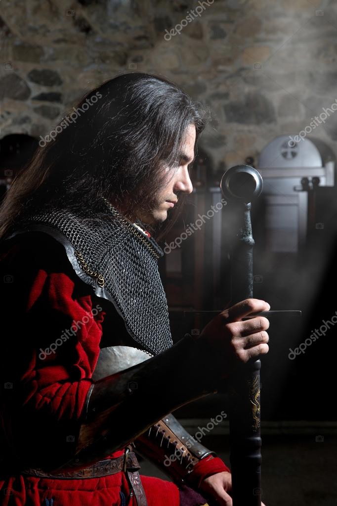 Side View of Knight Praying Before the Battle Against Stone Wall Stock ...