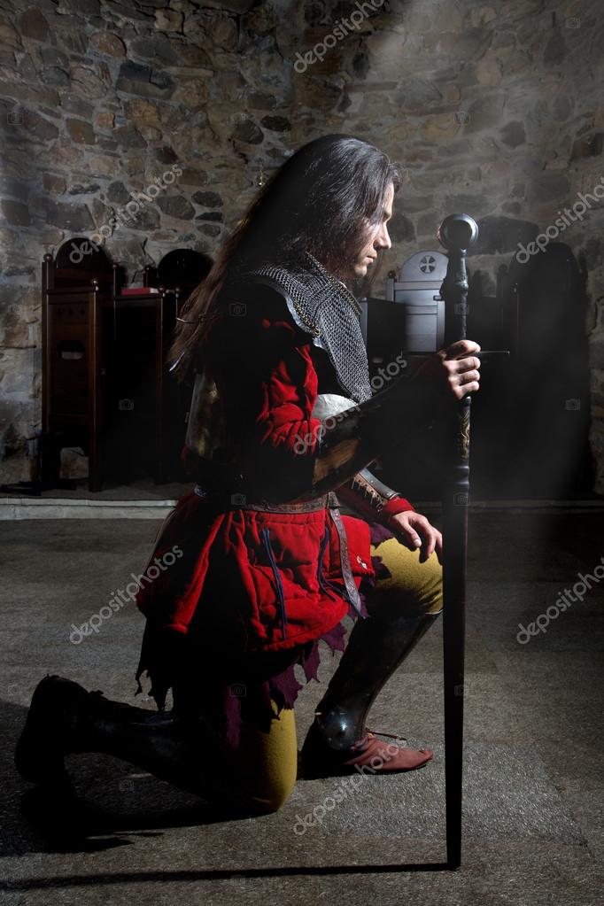 Side View of Knight With Sword Praying in the Old Church — Stock Photo ...