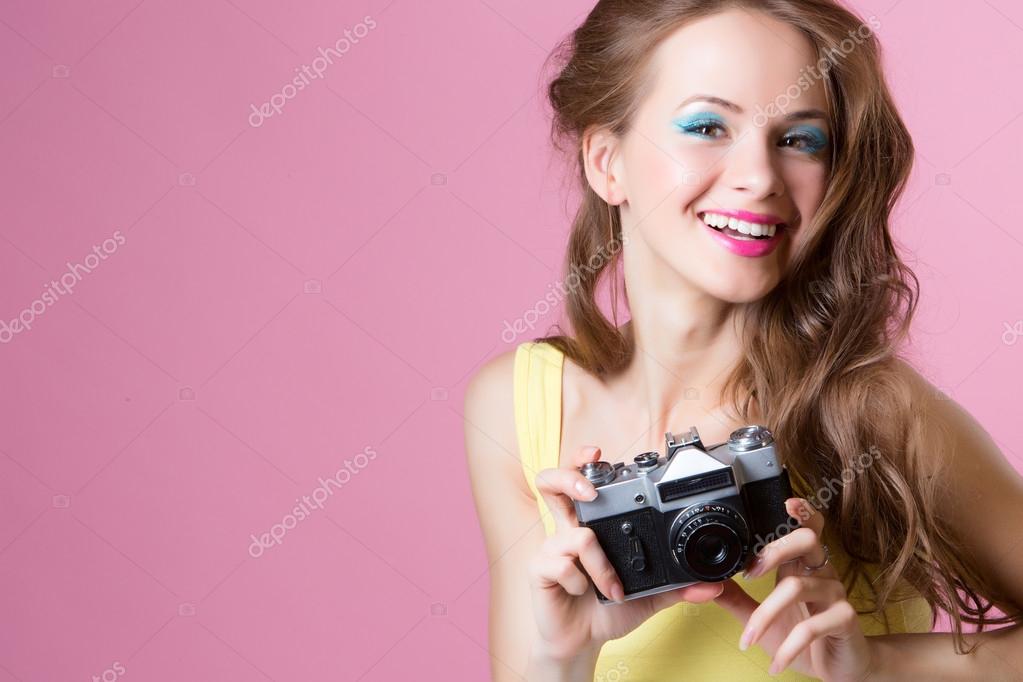 Young beautiful girl holding a camera in vintage style depicted Selfie ...