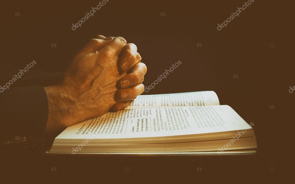 Man praying on the holy bible Stock Photo by ©IzelPhotography 95598488